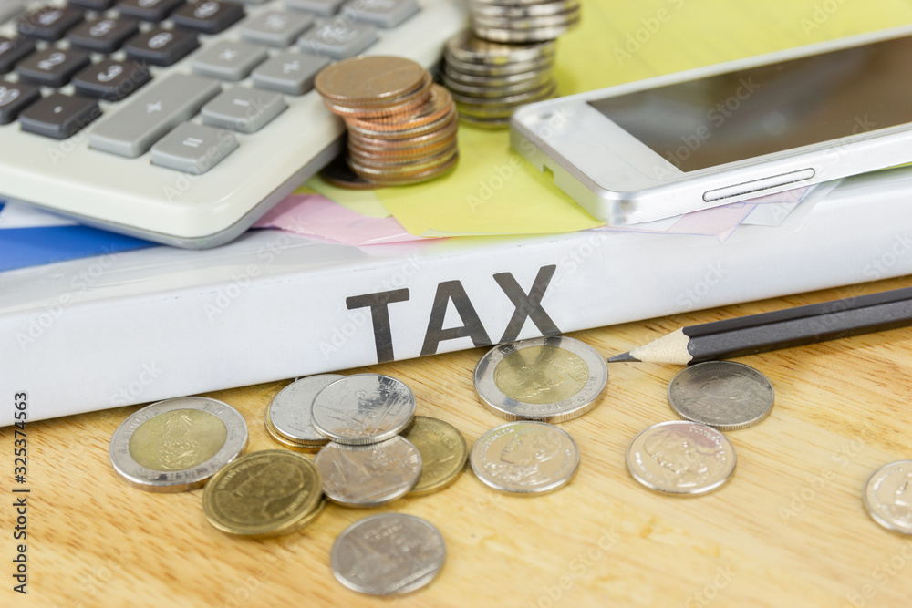 Folder Tax documents and paper files with coin calculator concept ...