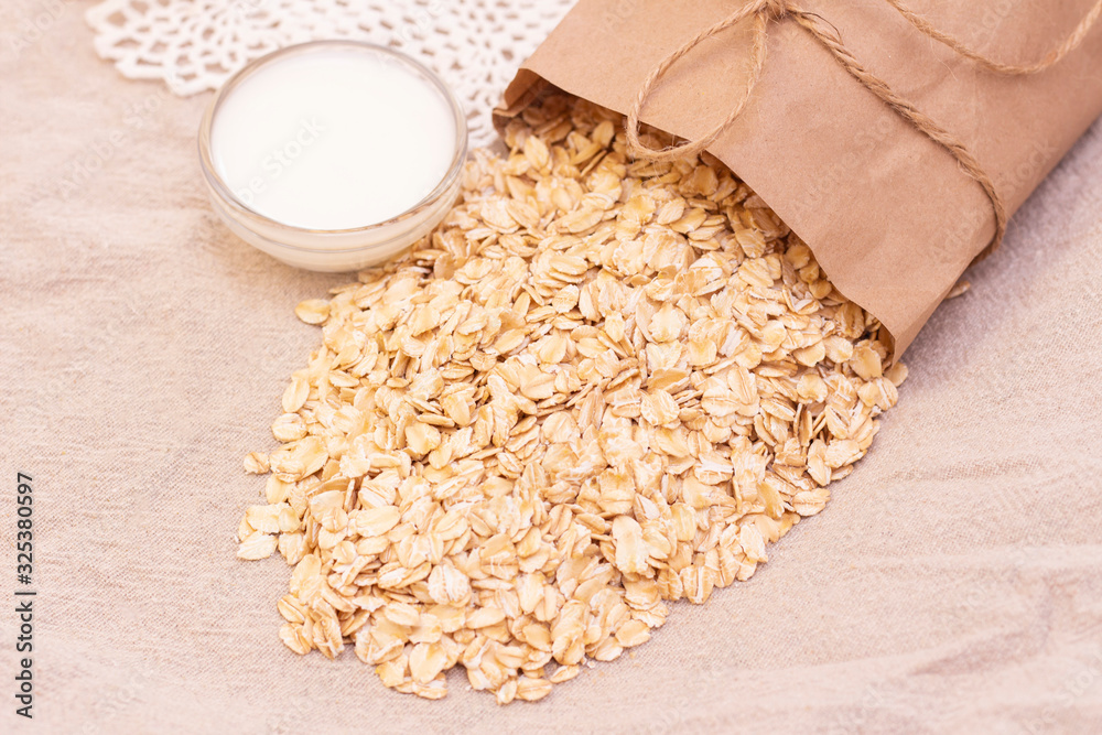 dry natural oat flakes. Oatmeal from an ecological paper bag. Natural ...