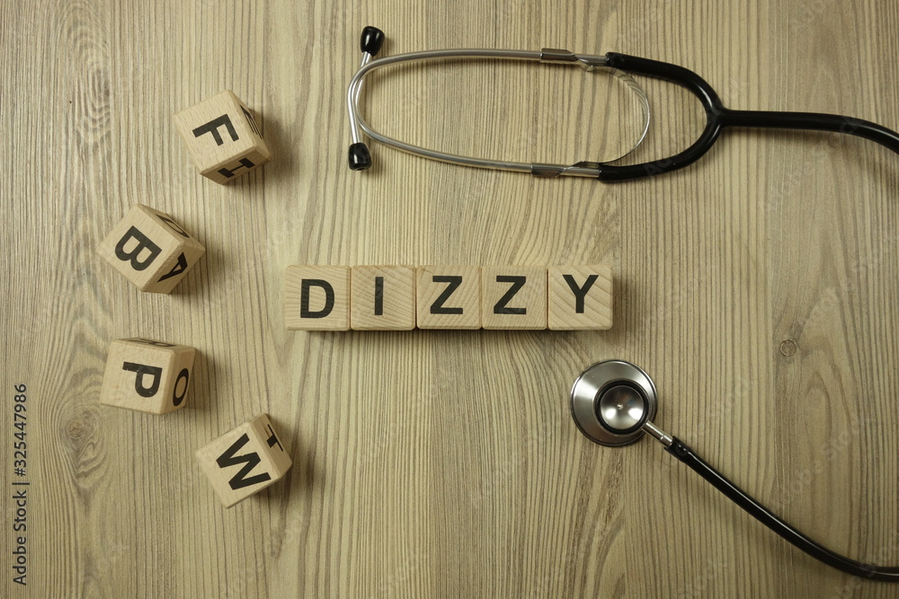 Word dizzy from wooden blocks with stethoscope Stock Photo | Adobe Stock