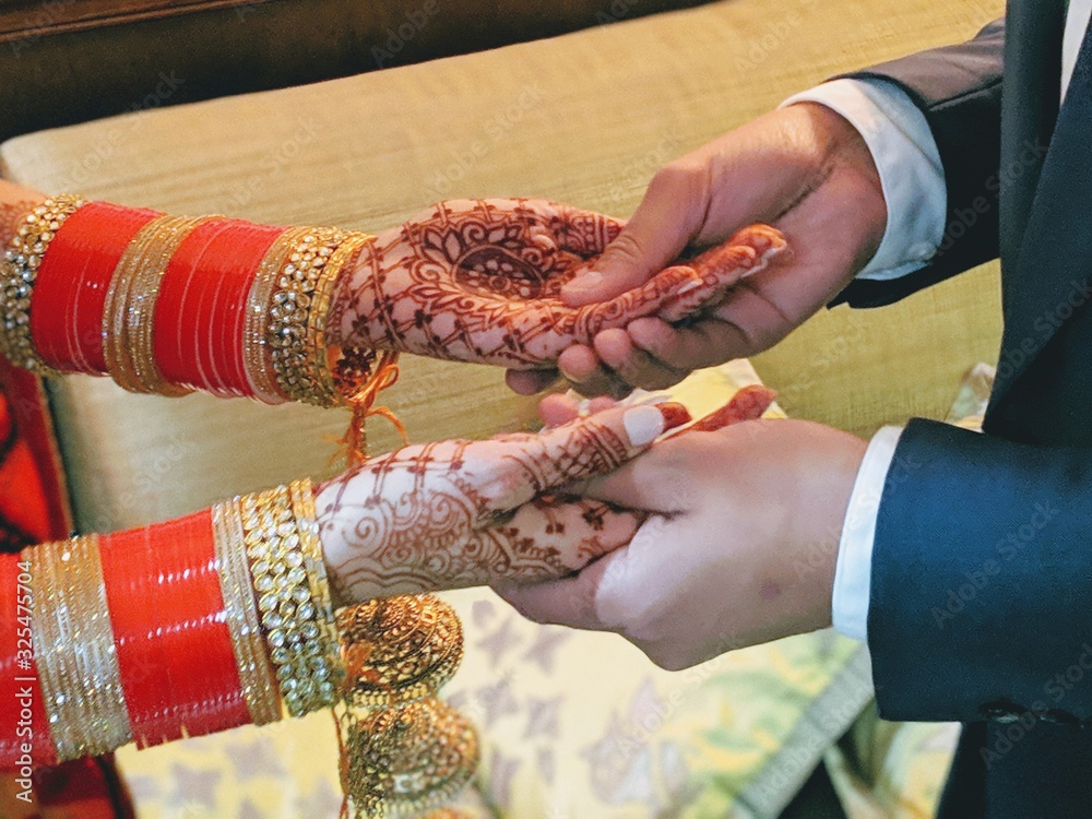 Bride and groom holding hands Indian Sikh wedding with henna tattoos ...