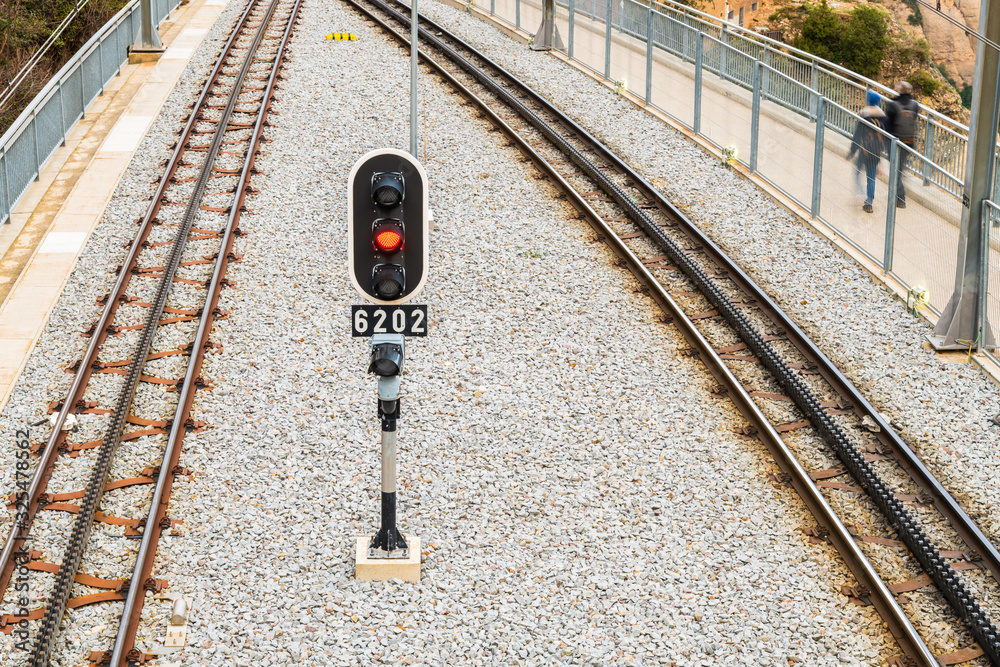 Train station with intersecting tracks and traffic light in red Stock ...
