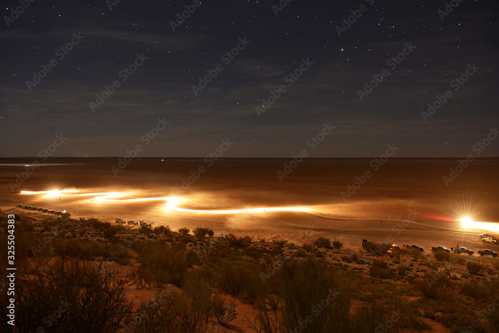 Gorgeous night trails of a race track on a salt pan in the Kalahari ...