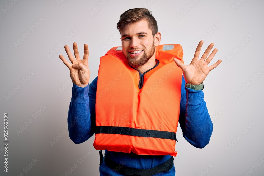 Young blond tourist man with beard and blue eyes wearing lifejacket ...