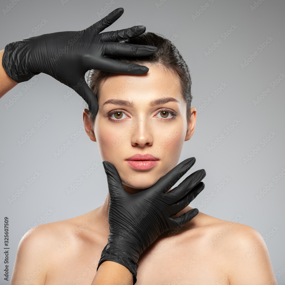 Doctor checks a skin before plastic surgery. Face skin check before ...