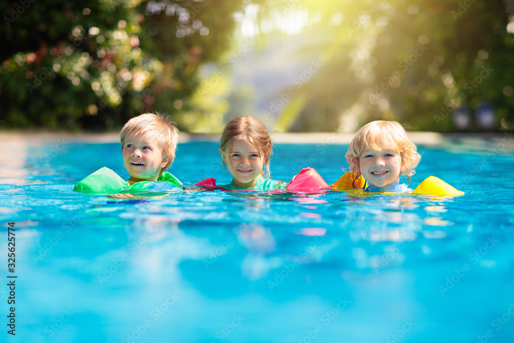 Kids in swimming pool. Life jacket for child. Stock Photo | Adobe Stock