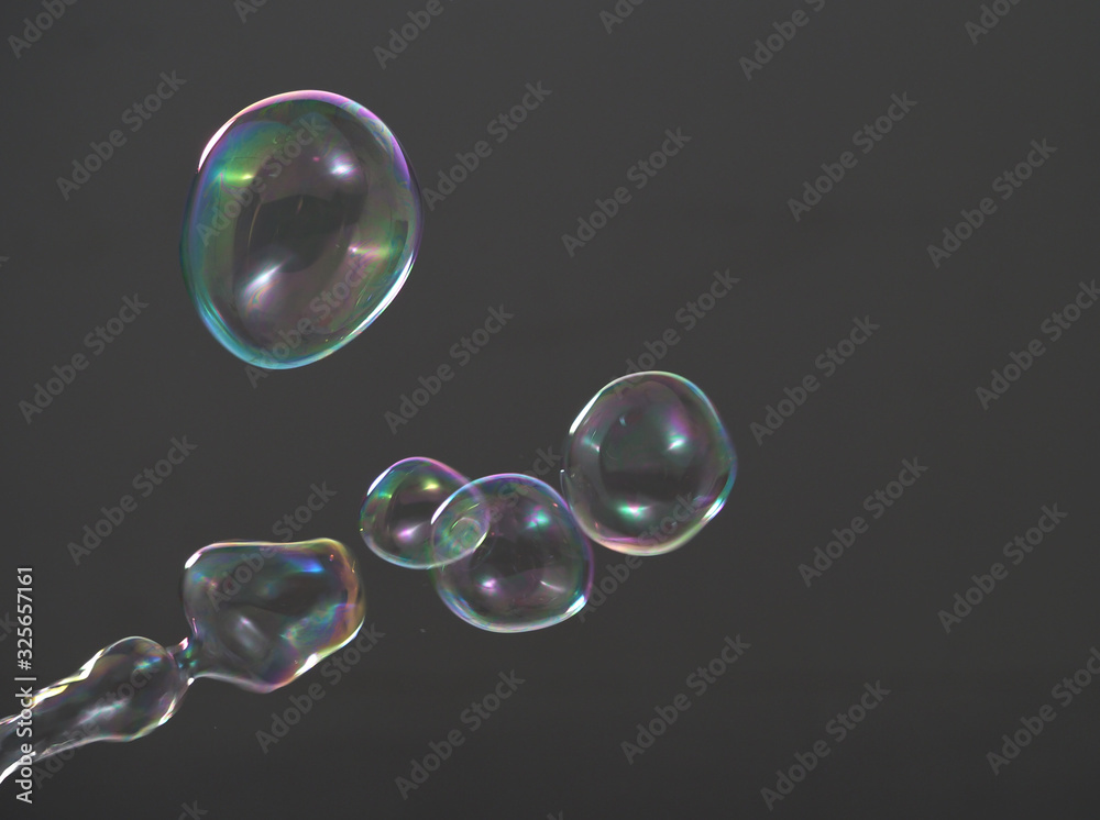 Real soap bubbles floating and moving on studio background which made ...