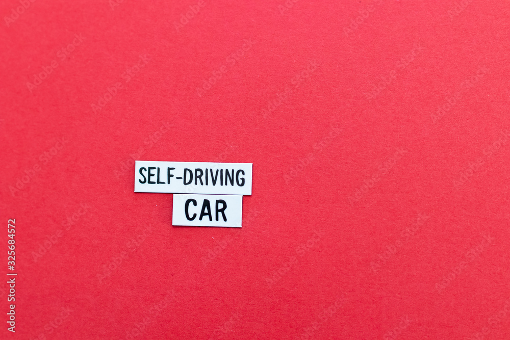 SELF DRIVING CAR text on label on red background. Autonomous driving ...