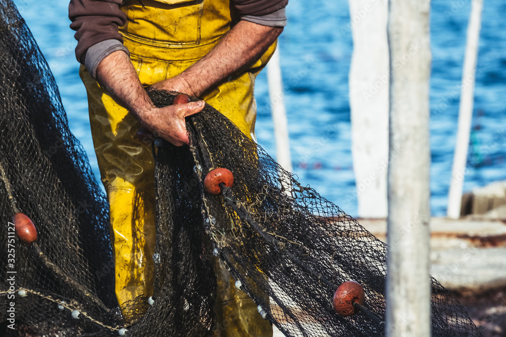 Mains d'un pêcheur en train de ranger ses filets de pêche Stock Photo ...