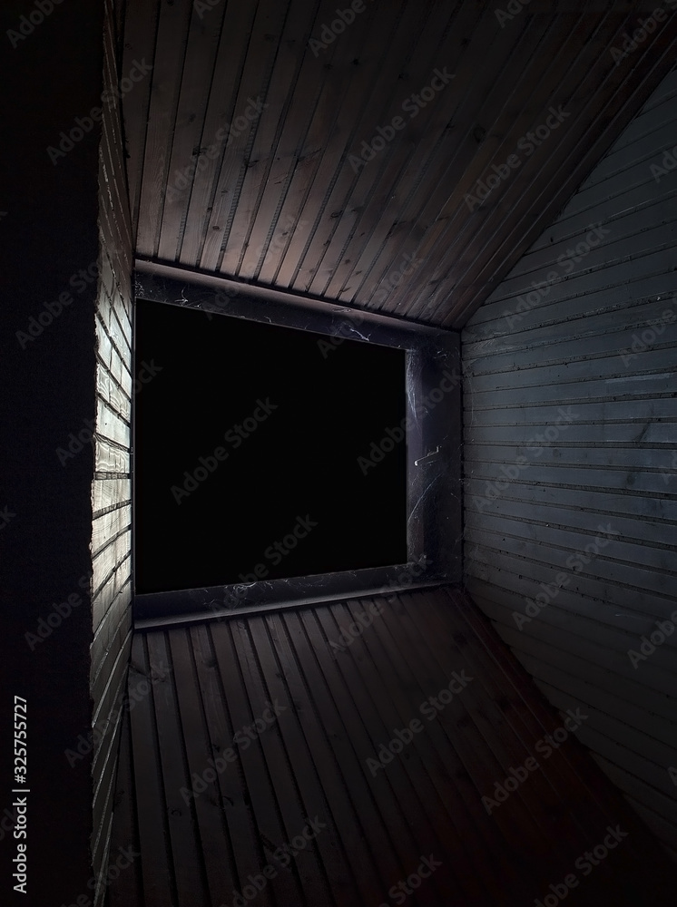 Interesting perspective of window in dark spooky attic and wooden ...