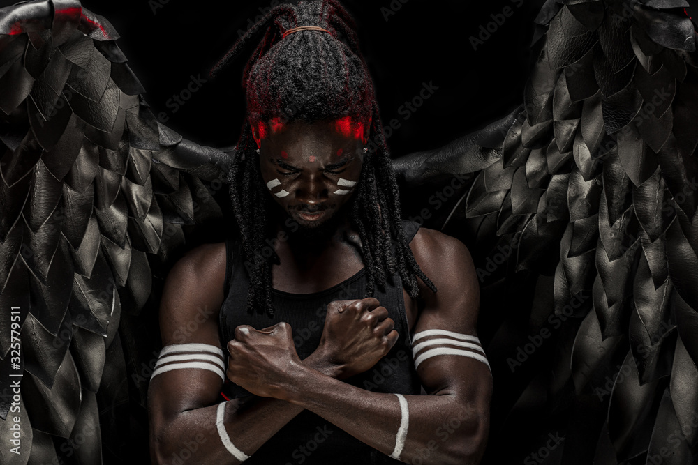 strong black angel with cool wings, stand posing at camera. man fall ...