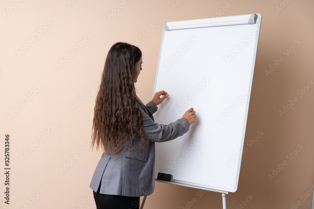 Young woman giving a presentation on white board giving a presentation ...