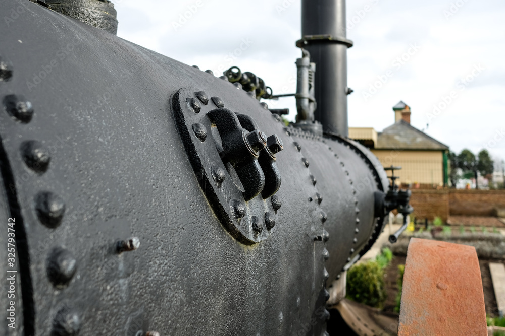 Shallow focus of a boiler plate and rivets seen on a very old, steam ...