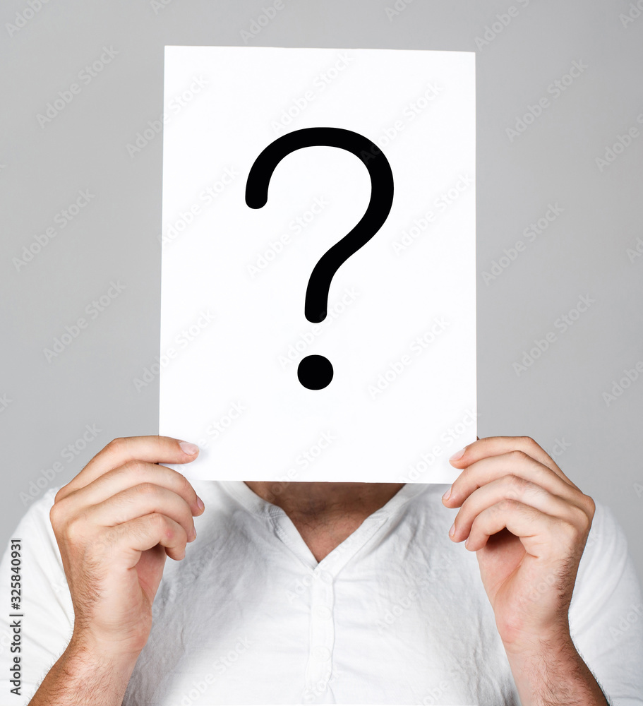 Foto de Anonymous man, peeking behind of interrogation symbol. Male ...