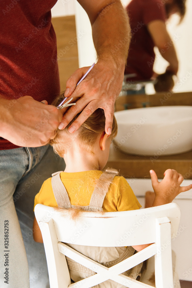 Dad cutting hair to little son Stock Photo | Adobe Stock