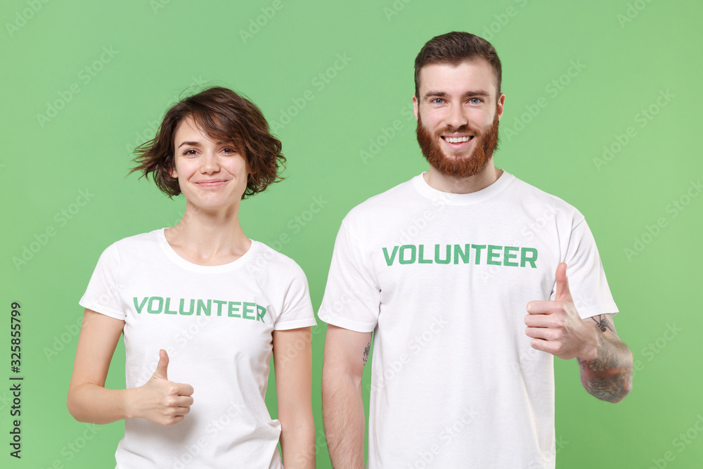 Smiling two young friends couple in white volunteer t-shirt isolated on ...