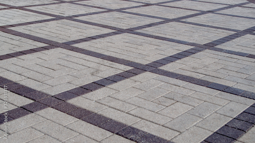 Street square area lined with rectangular gray paving slabs with ...