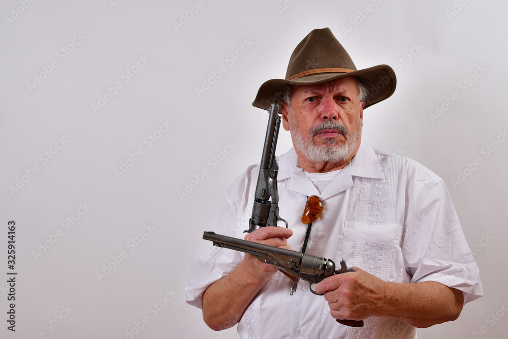 Angry old man with two revolvers..Elderly gentleman with floppy hat and ...