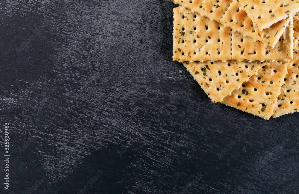 Top view crackers with copy space on black stone background horizontal ...