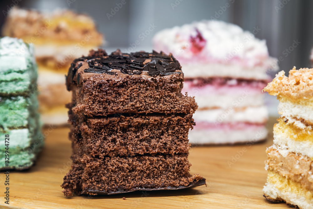 assorted sponge cakes with different fillings on the window of the ...