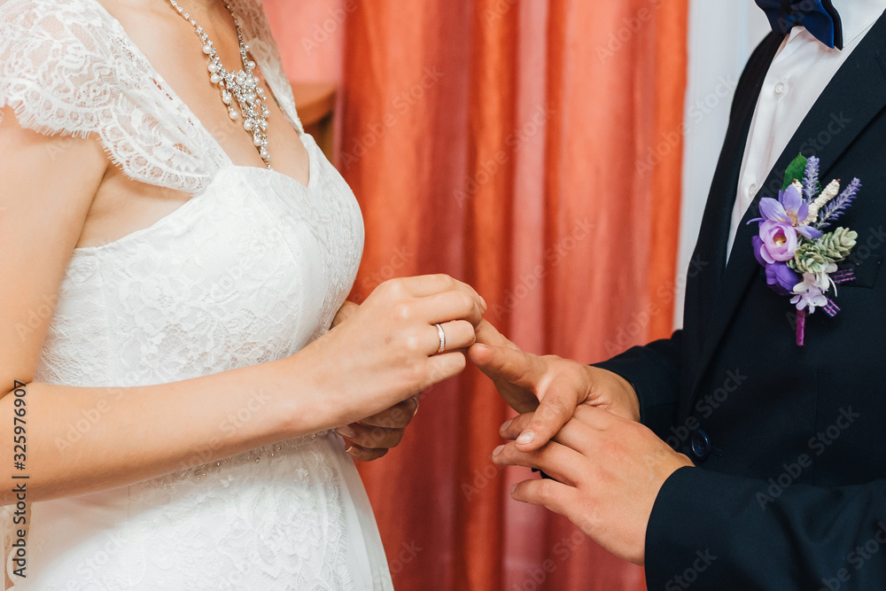 traditional wedding ceremony of exchange of gold rings between the ...