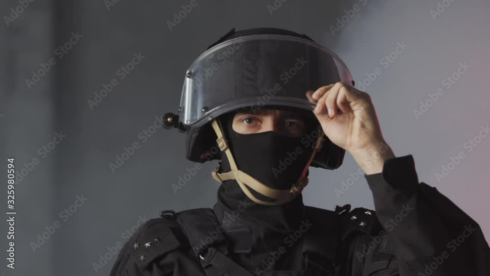 uniformed police or military forces holding back mass protest, state ...