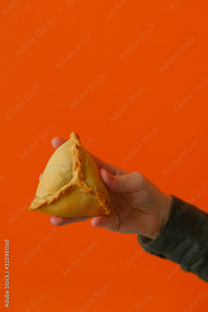Echpochmak Tatar traditional dish. Echpochmak in hand on an orange ...
