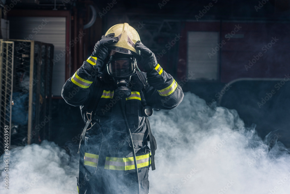 Fireman standing confident holding helmet and wearing firefighter ...