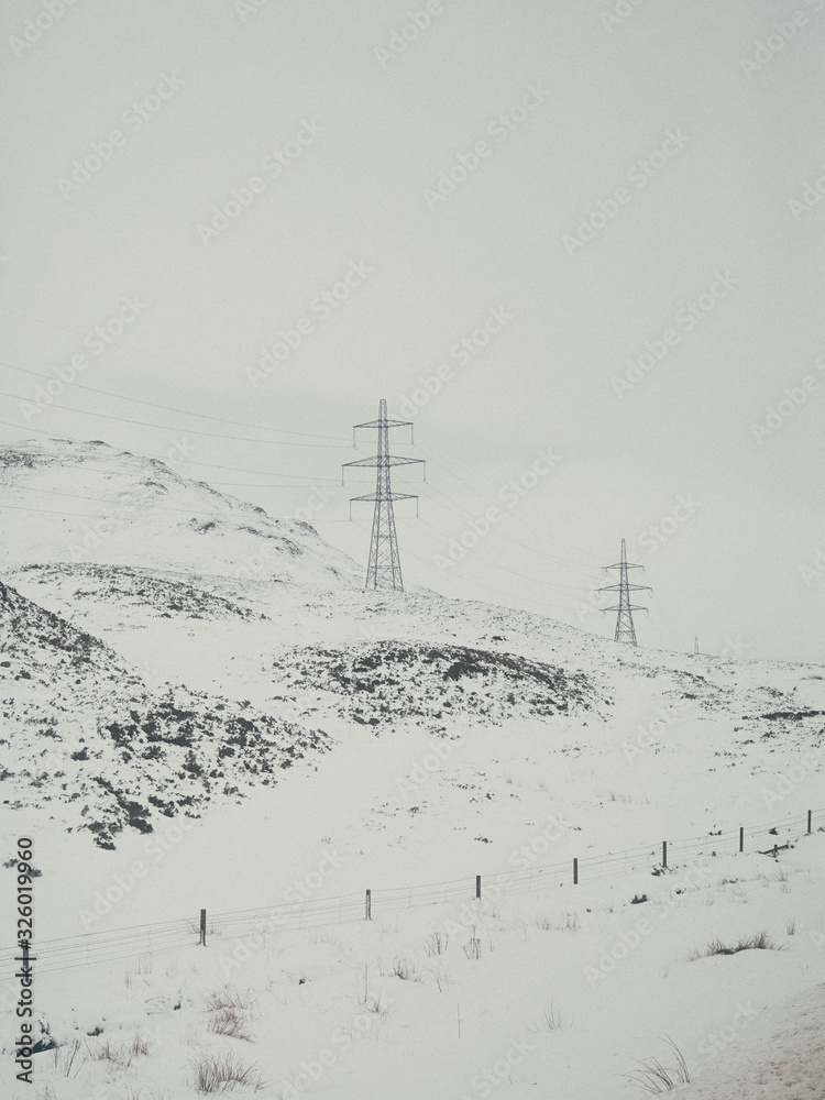 high voltage power lines in the snow Stock Photo | Adobe Stock