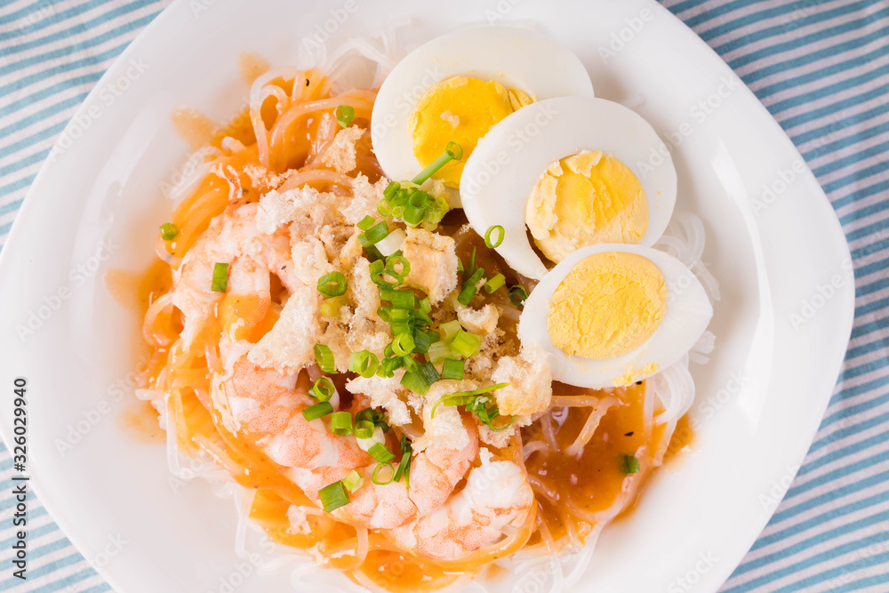 thick rice noodles with shrimp sauce, crispy pork skin and boiled egg ...