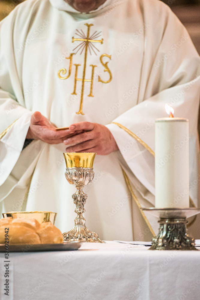 Priest giving Eucharist Stock Photo | Adobe Stock