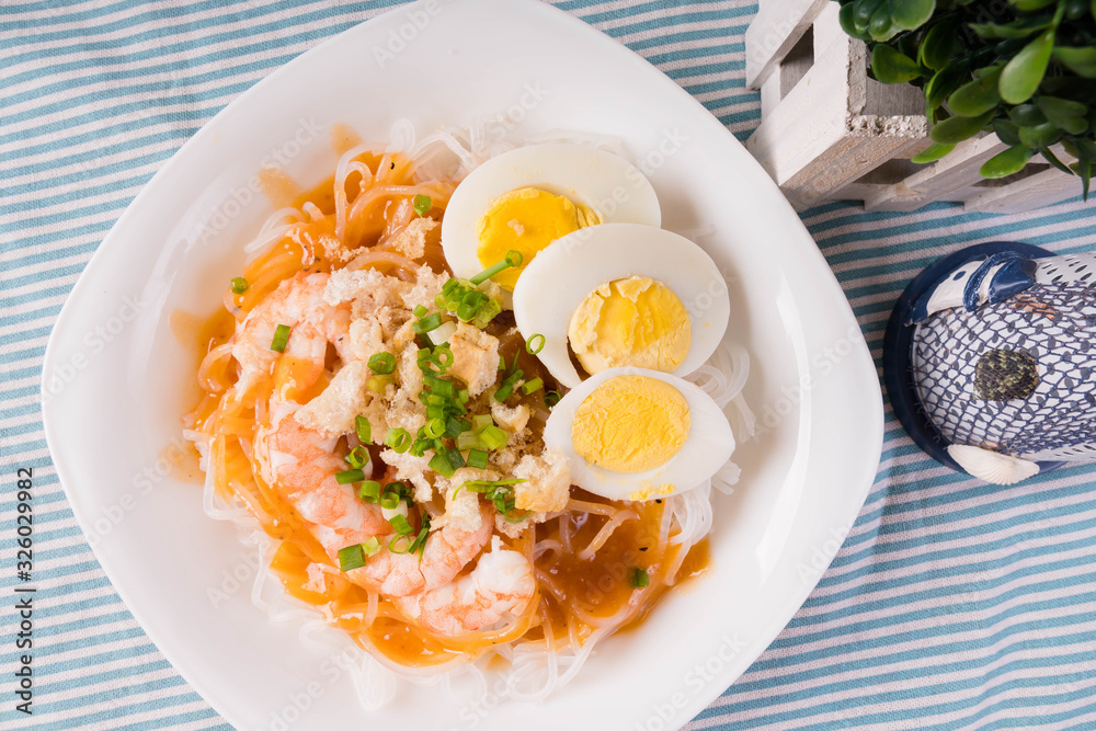 thick rice noodles with shrimp sauce, crispy pork skin and boiled egg ...