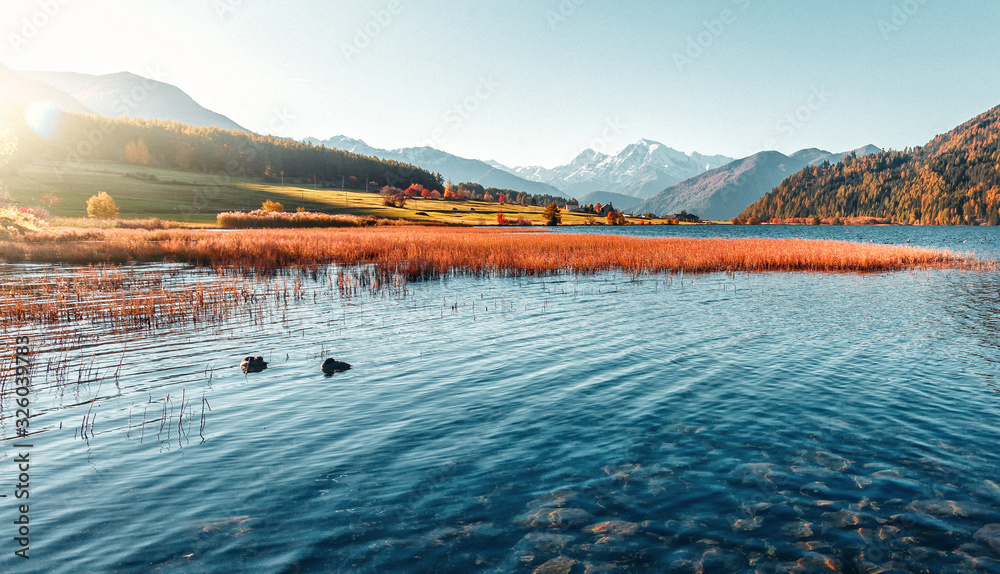 Scenic image of fairy tale Mountain lake under sunlit. Wonderful Resia ...
