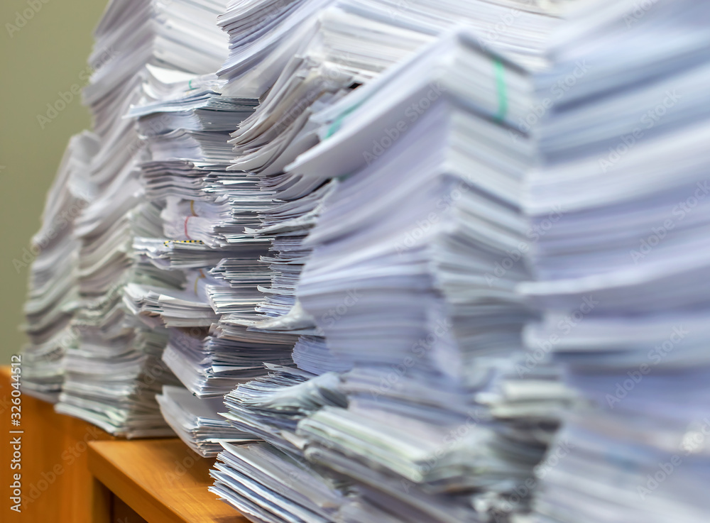 bundles bales of paper documents. stacks packs pile on the desk in the ...