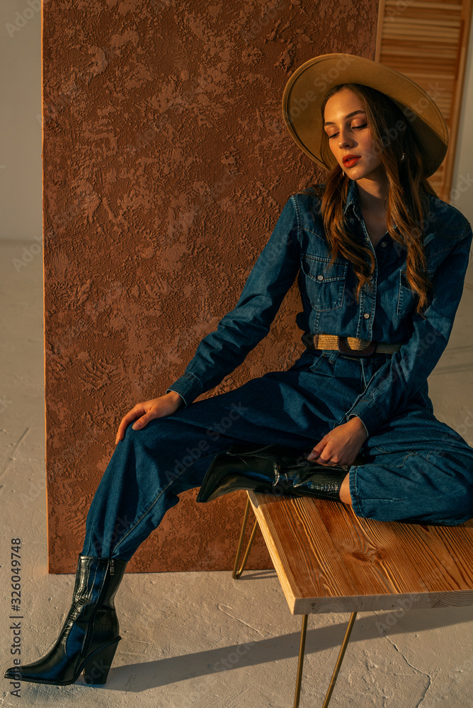 Full-length fashion portrait of young confident woman, model, wearing ...