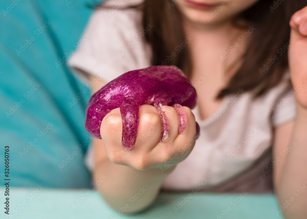 Hand Holding Homemade Slime. Toy for children mucus and liquid flowing ...