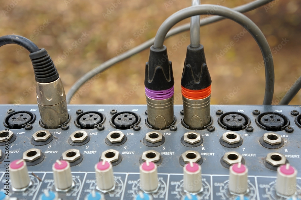 XLR connector for microphone cables are connected to sound music mixer ...