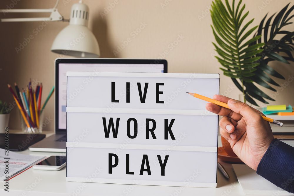 Live Work Play concepts with text on light box on desk table in home ...