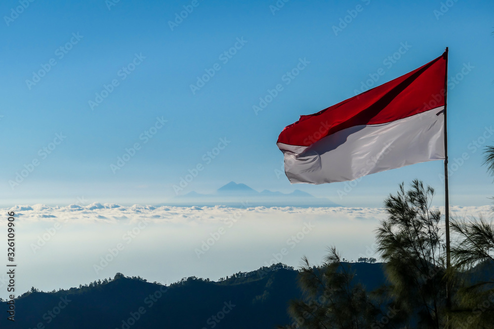 An Indonesian flag waving with the wind seen from the top of Mount ...