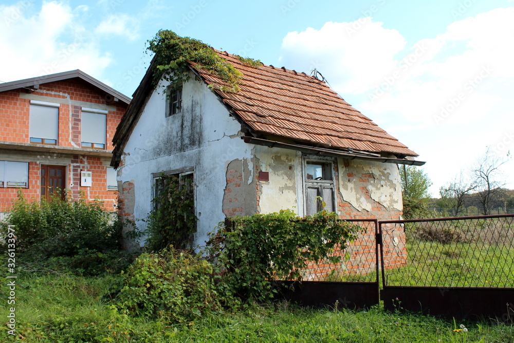 Very small abandoned old red brick family house ruins with broken ...