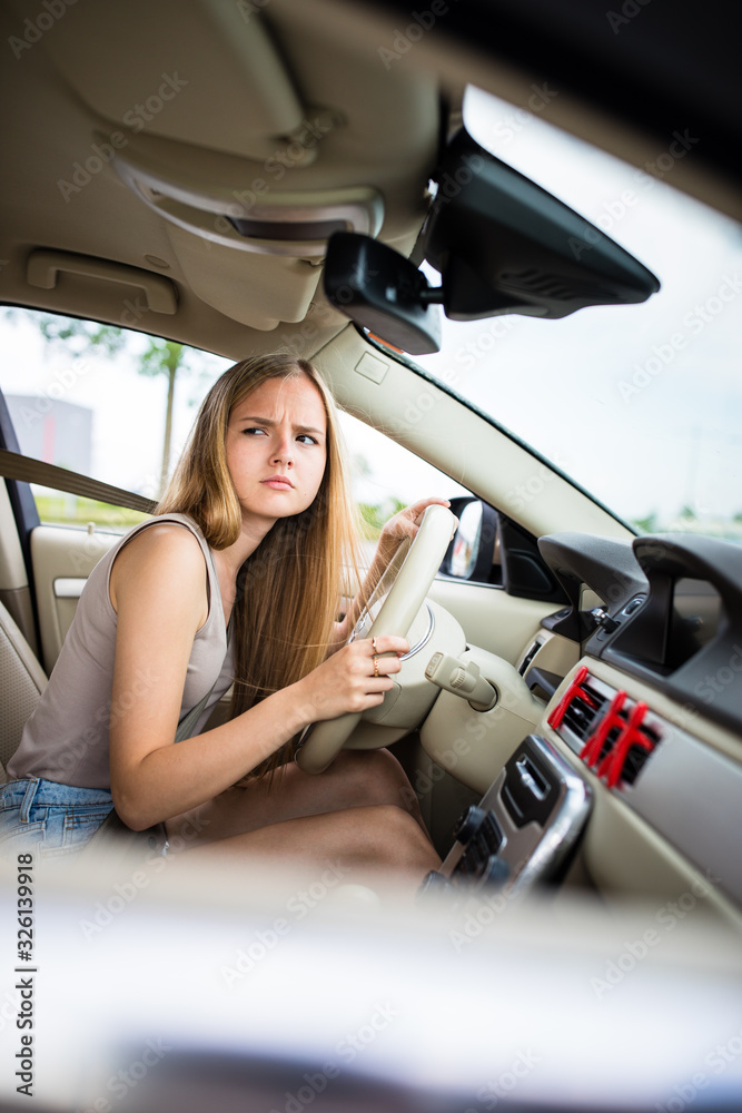 Cute female teen driver enjoying her freshly acquired driving license ...
