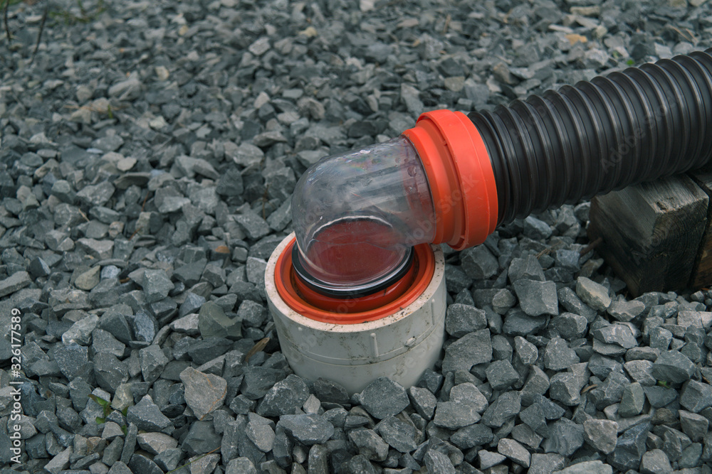 RV sewer hose connected to dump station with 90 degree clear fitting ...