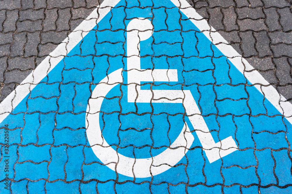 Handicapped parking sign on the ground. Wheelchair symbol. White and ...
