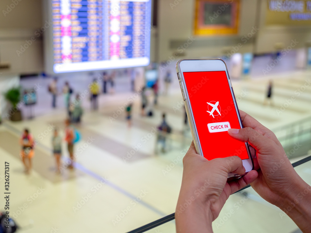 Flight check-in by mobile phone. Hand touching on smartphone screen to ...