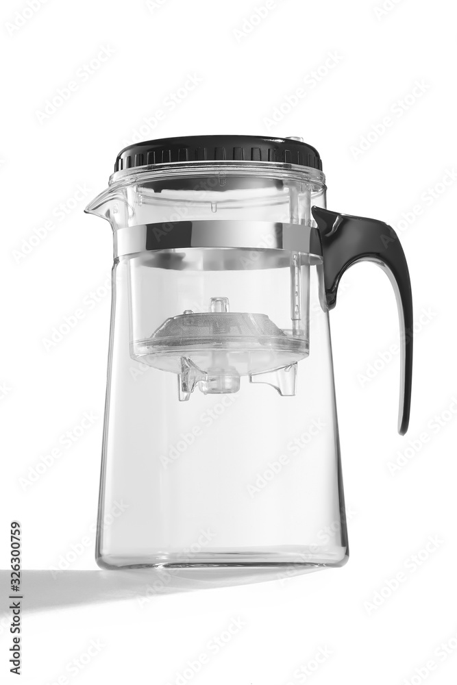 Subject shot of a clear glass teapot with a removable infuser and ...