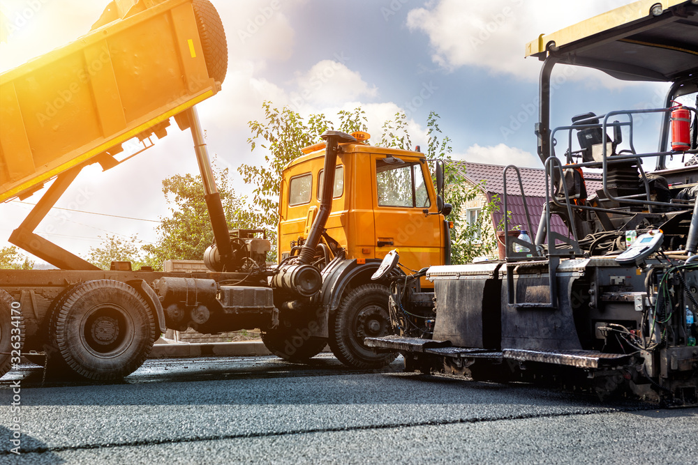 Asphalt higway road construction site. Heavy industrial machinery at ...