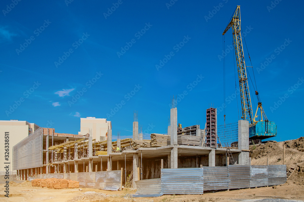 Construction site background. Hoisting cranes and new multi-storey ...