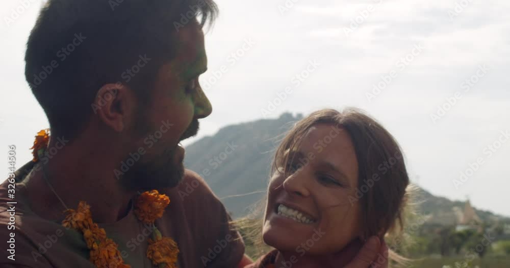 Handheld shot of garland couple embracing, hug, run, kiss, jump and ...