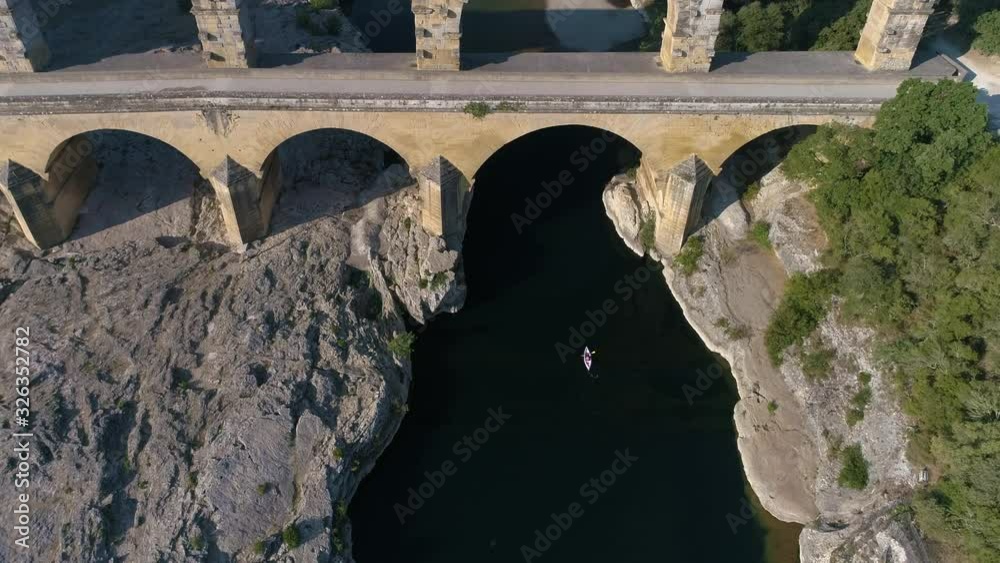 Aerial shot of Canoe Kayak, alone on the Gardon River under the Pont du ...