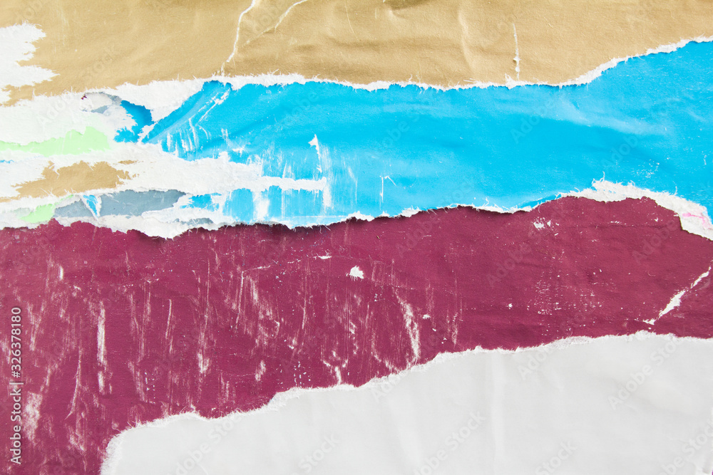 Blue, purple and white torn, crumpled and shabby paper placards on wall ...