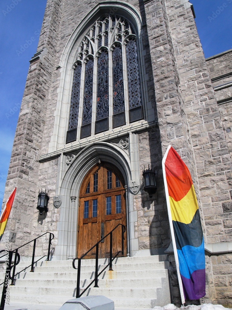 Rainbow banner welcomes LGBTQ parishoners to a Gothic church Stock ...